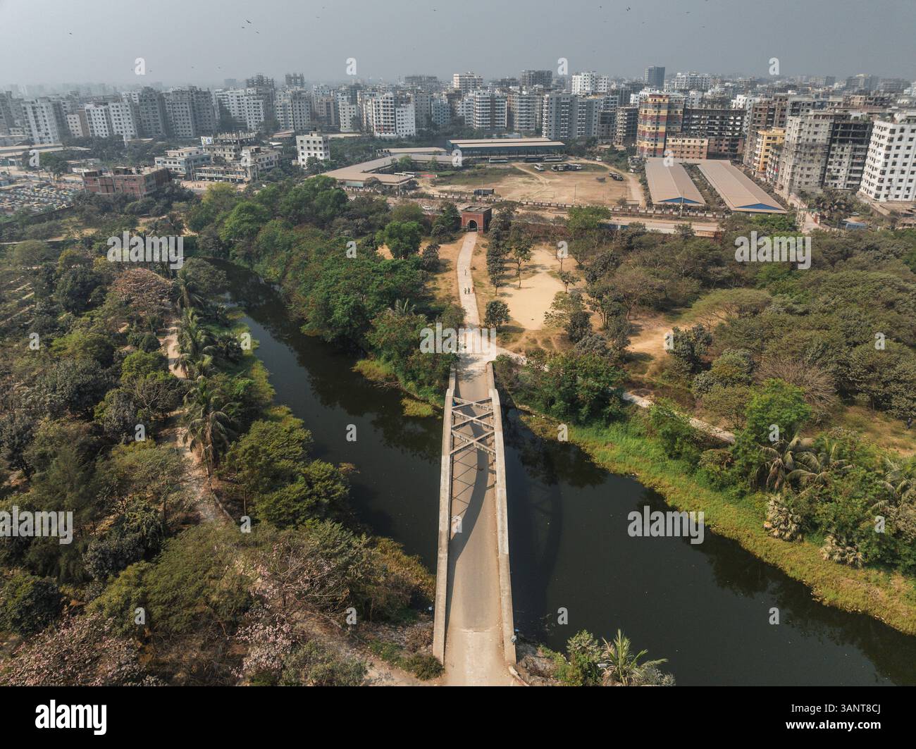 Aerial view of urban landscape featuring buildings, a bridge, and a ...