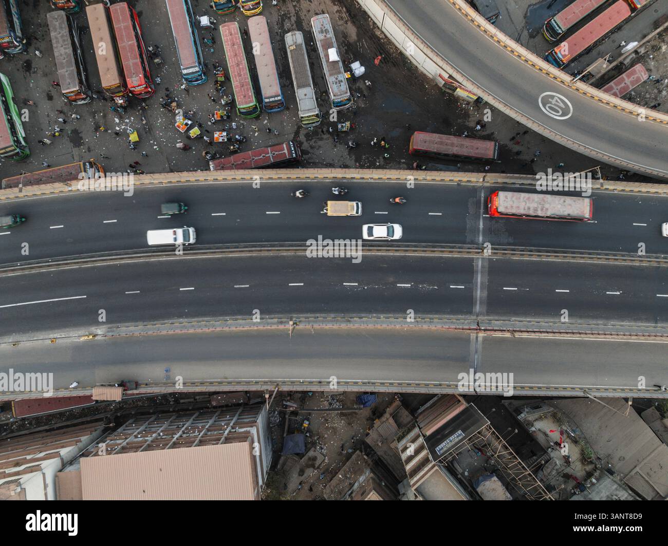 Aerial view of busy junction road with a bus station and various ...