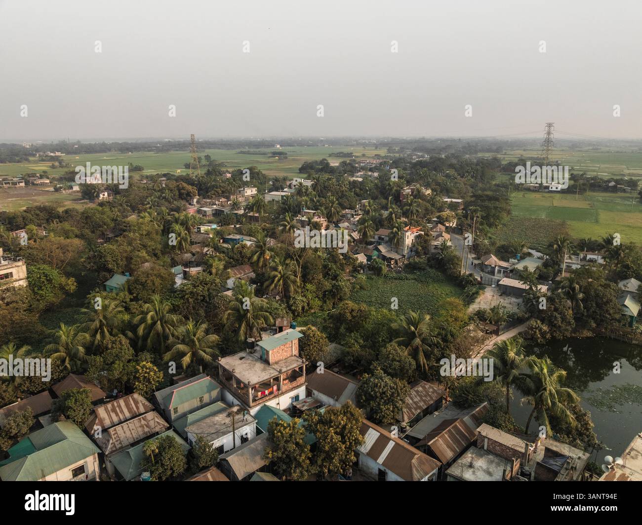 Aerial view of a tranquil rural village surrounded by lush greenery and ...