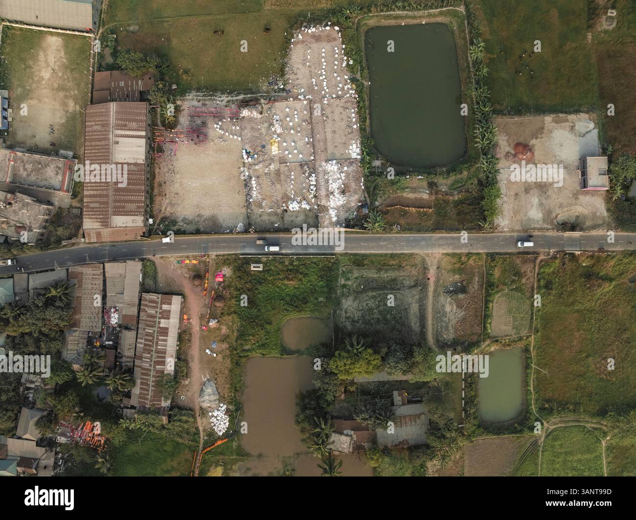 Aerial view of rural landscape with fields, ponds, and buildings ...