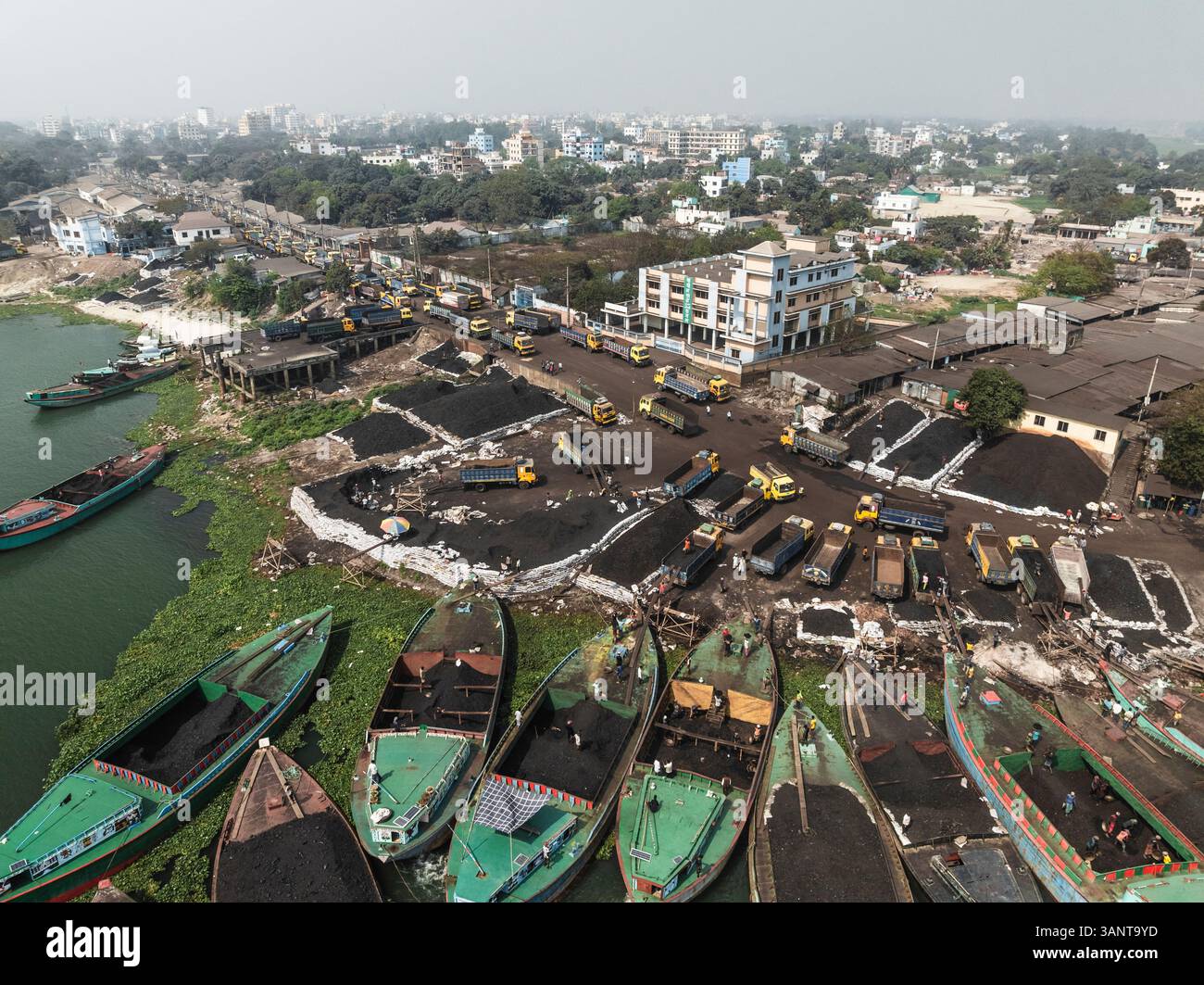 Aerial view of the Meghna River with industrial coal factory and urban ...