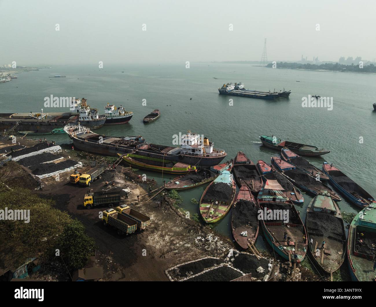 Aerial view of busy harbor with cargo ships and boats along the Meghna ...