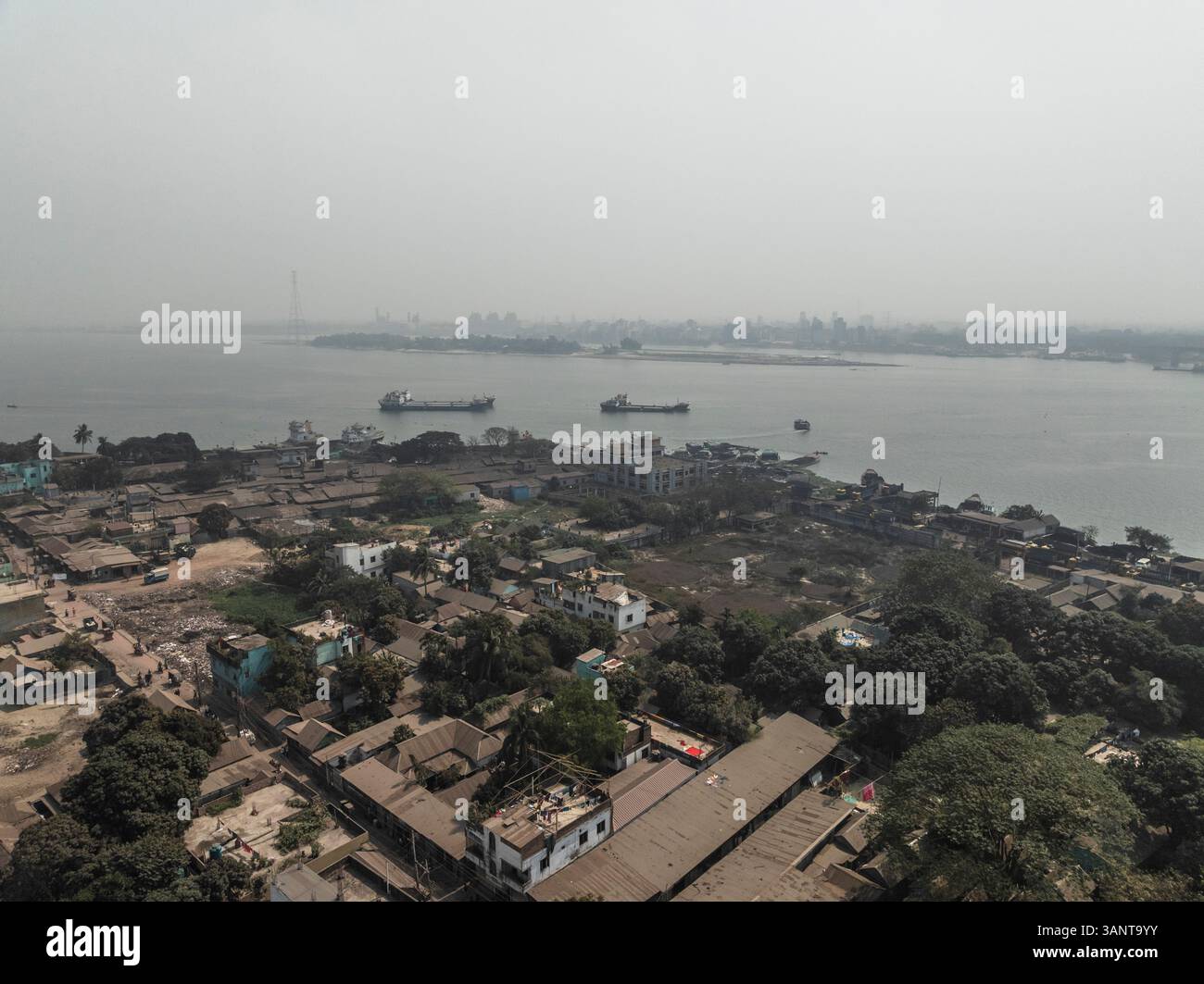 Aerial view of the Meghna River with urban buildings and boats, Bhairab ...