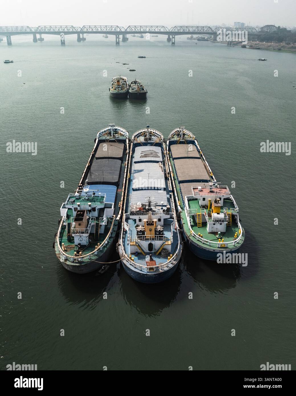 Aerial view of boats navigating the serene Meghna River with a bridge ...