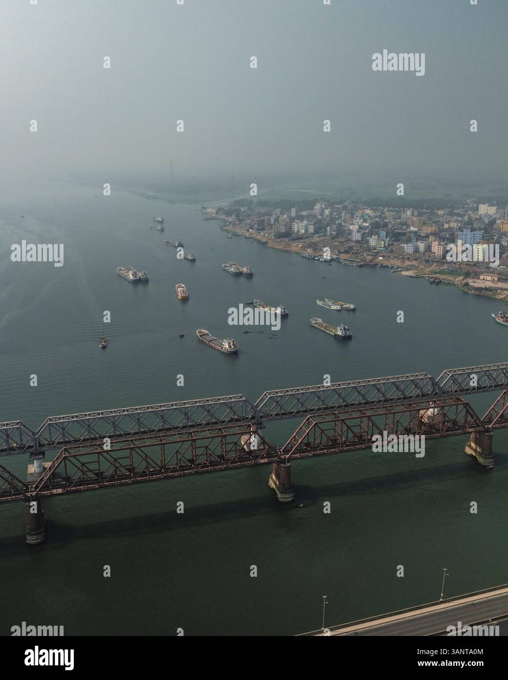 Aerial view of the bustling cityscape with the Meghna River, bridge ...