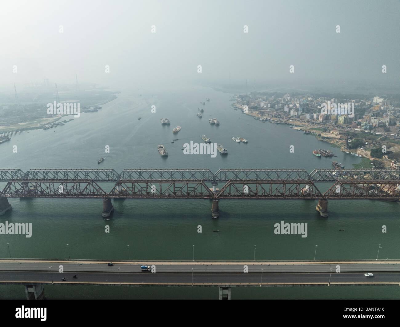 Aerial view of the beautiful Meghna River with a bridge and cityscape ...