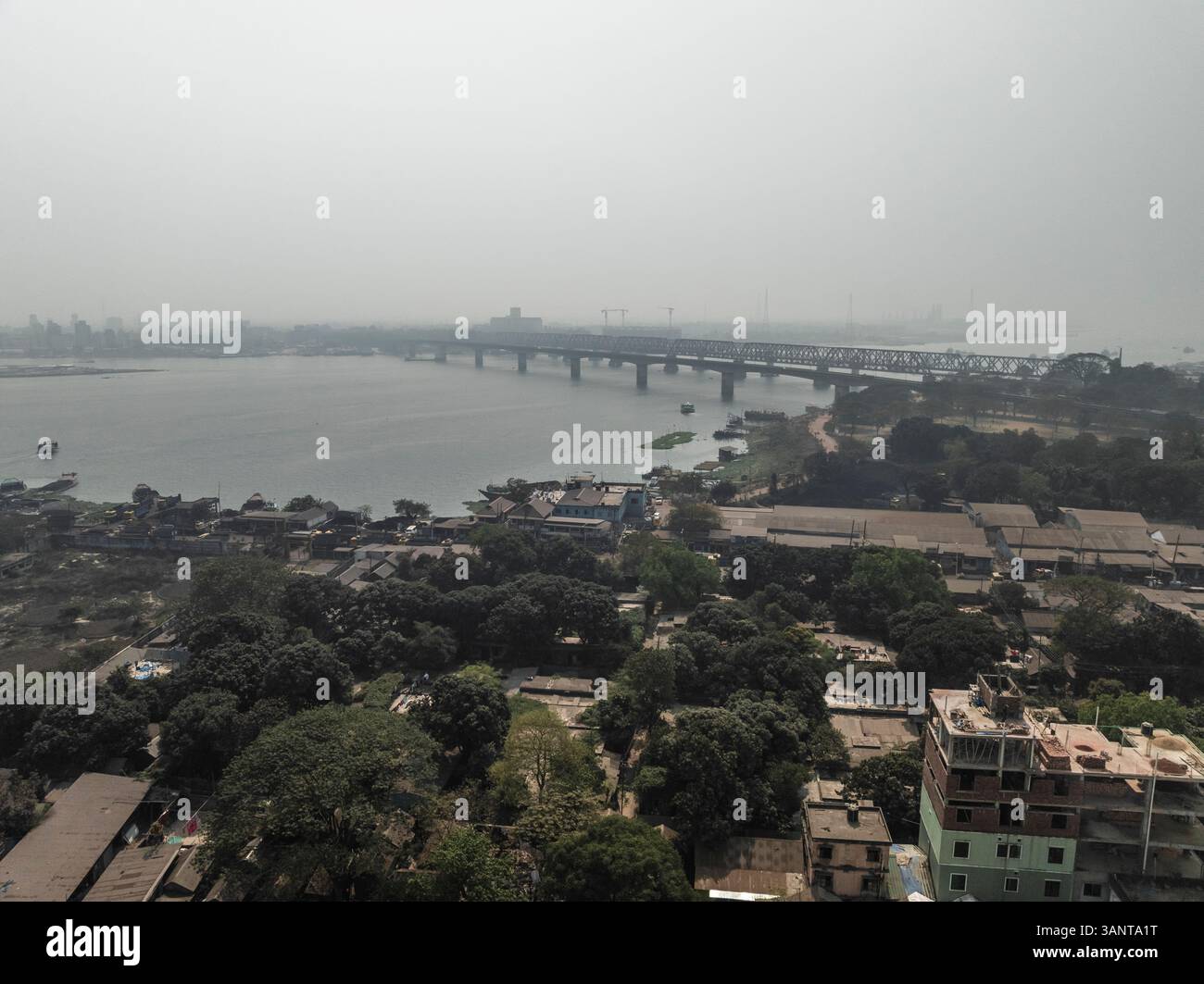 Aerial view of the beautiful Meghna River with urban buildings and a ...