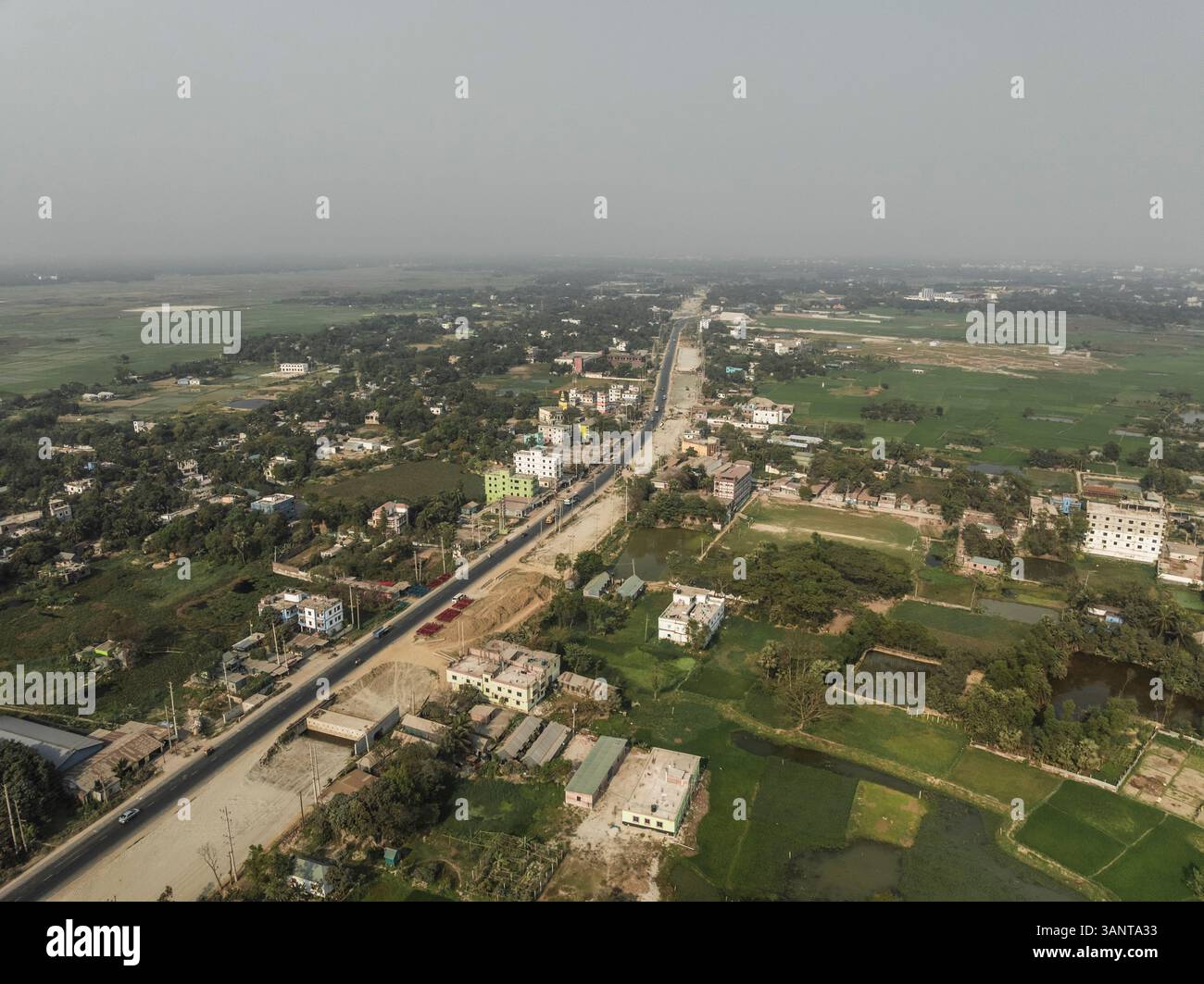 Aerial view of a peaceful rural village with greenery, fields, and ...