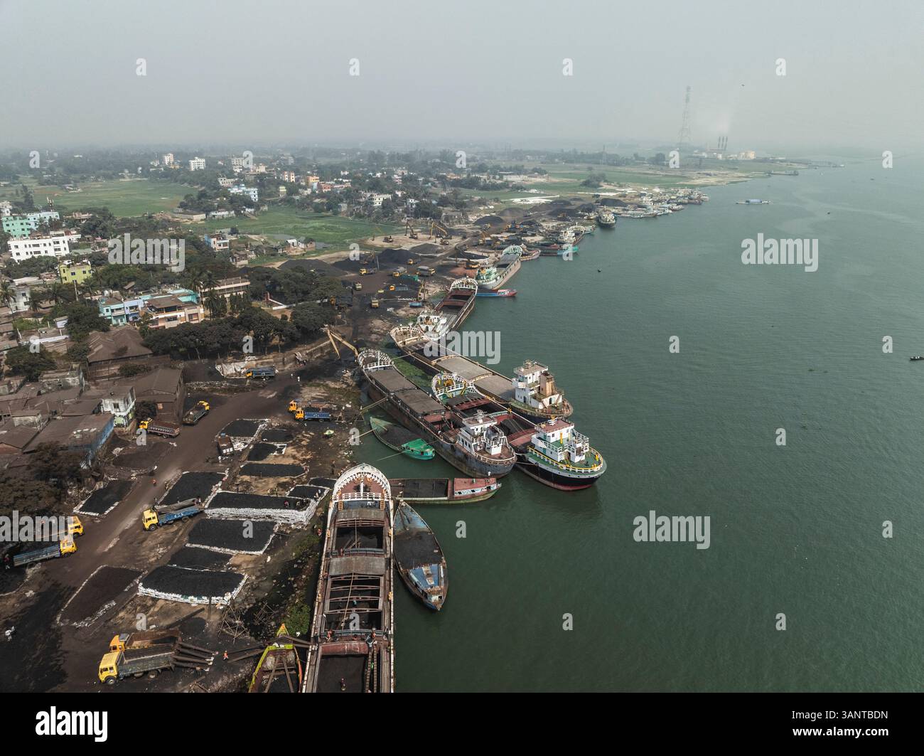 Aerial view of the Meghna River with industrial coal factory and ...