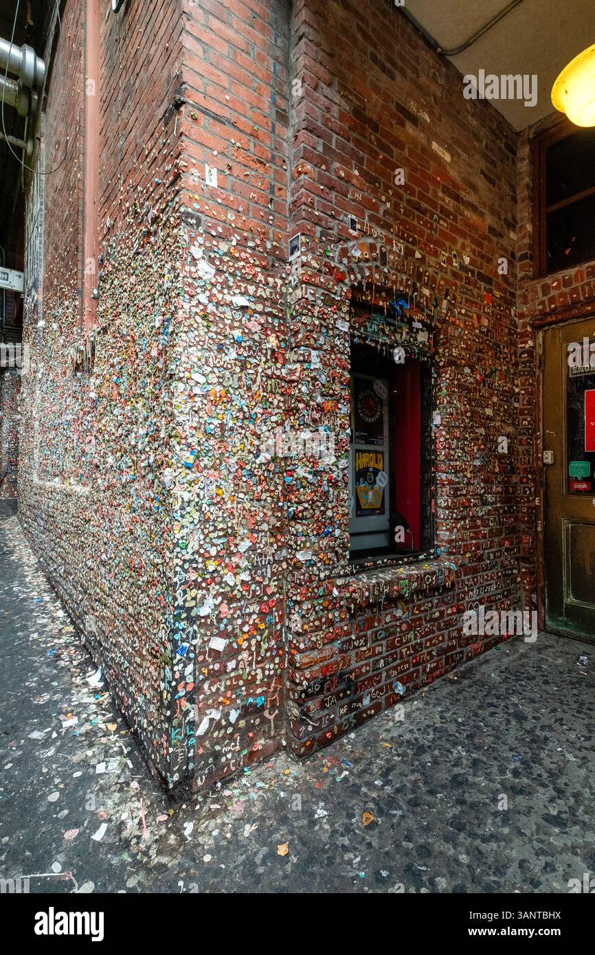 Colorful gum-covered urban alley with vibrant textured brick walls ...