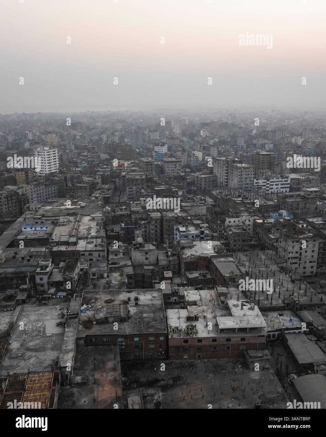 Aerial view of a crowded urban skyline with high-rise buildings at dusk ...
