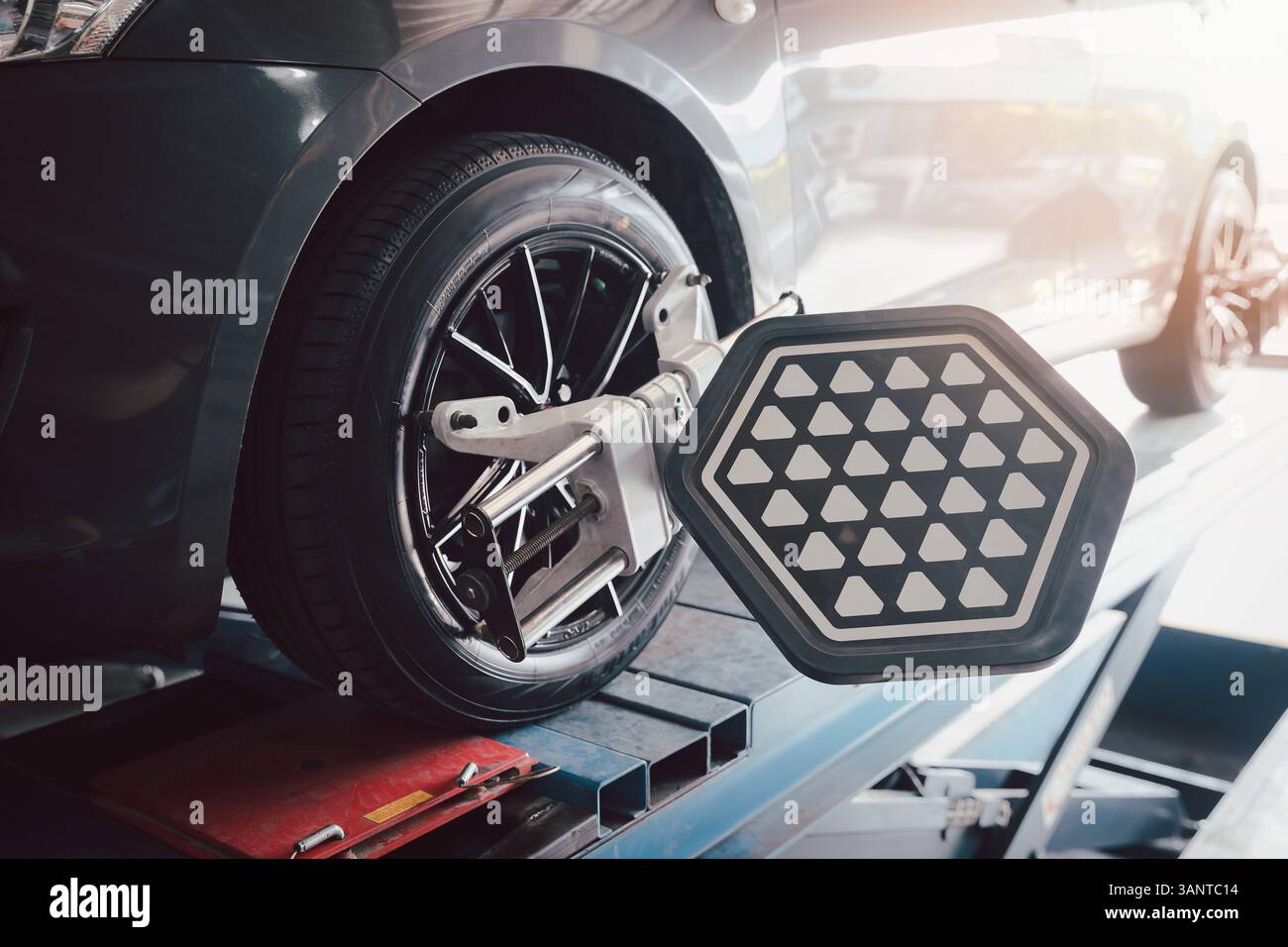 Car wheel balancer calibrate with laser reflector attach on each tire ...