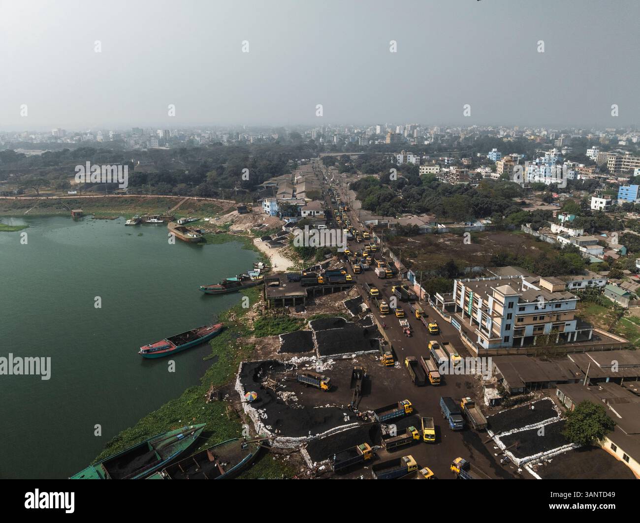 Aerial view of the Meghna River with a coal factory and urban landscape ...