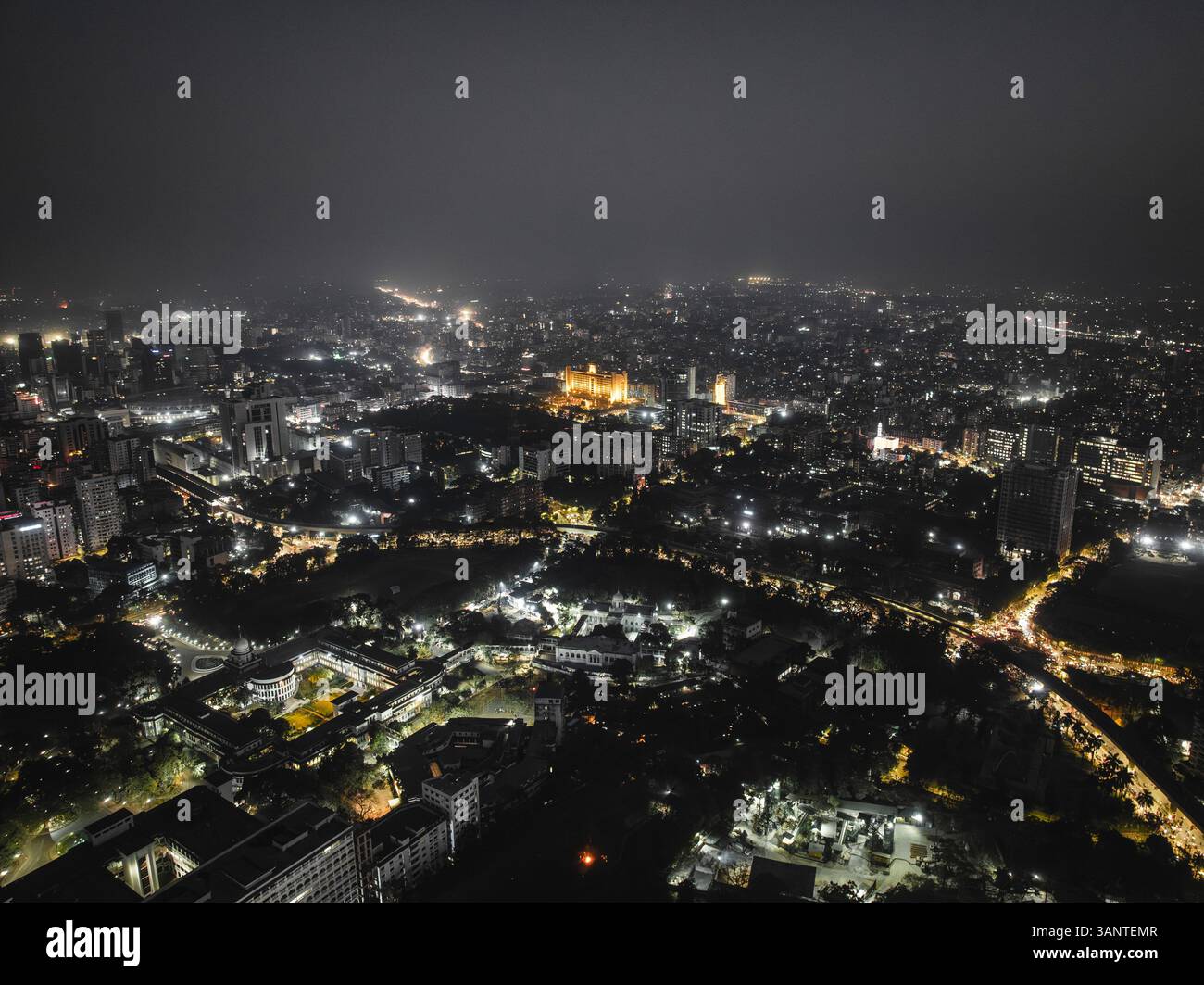 Aerial view of a vibrant cityscape with illuminated buildings and busy ...