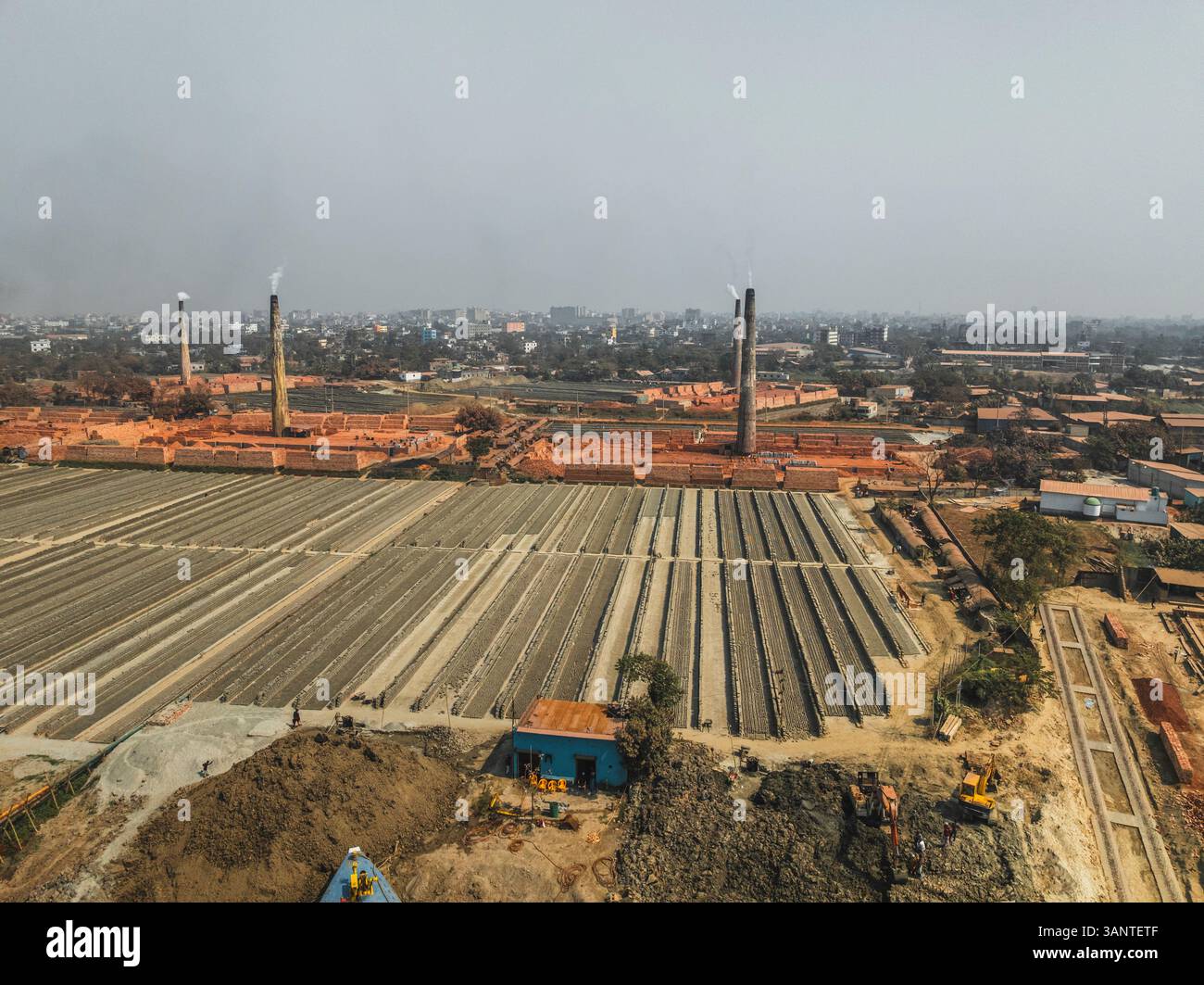 Aerial view of industrial brick fields with factories and chimneys ...