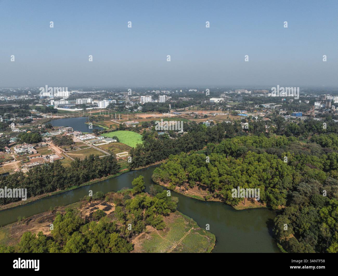 Aerial view of a beautiful urban landscape with greenery, river, and ...