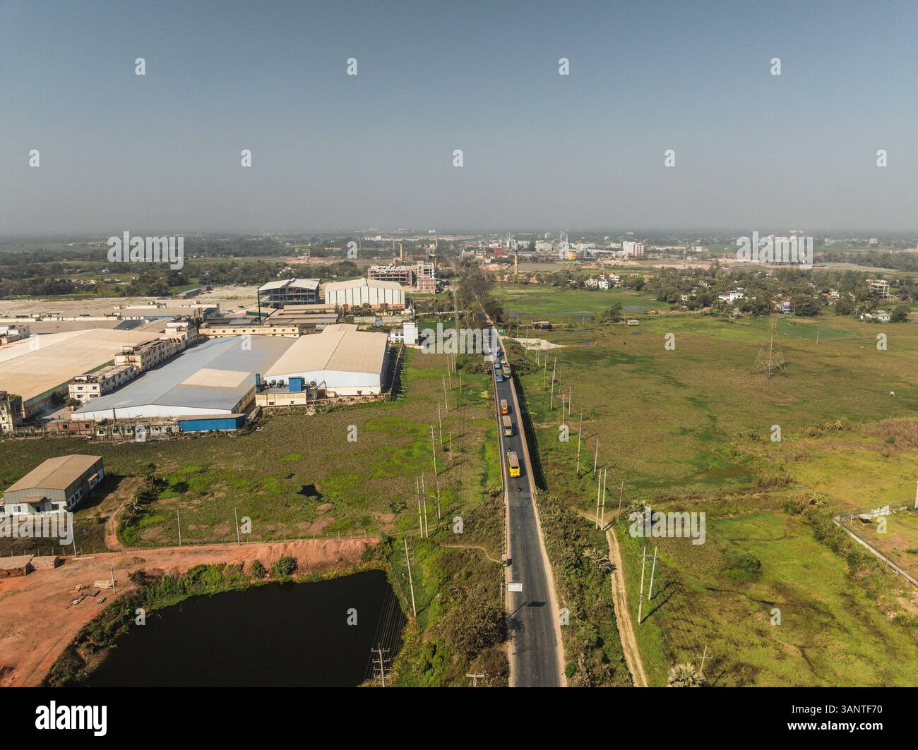 Aerial view of industrial area with factories, green fields, and roads ...