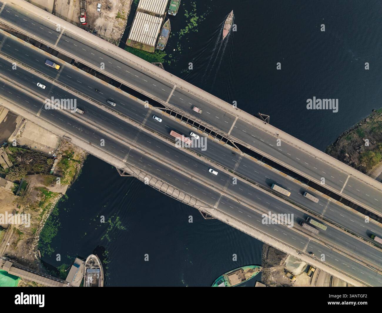 Aerial view of a modern bridge crossing over a river with vehicles and ...