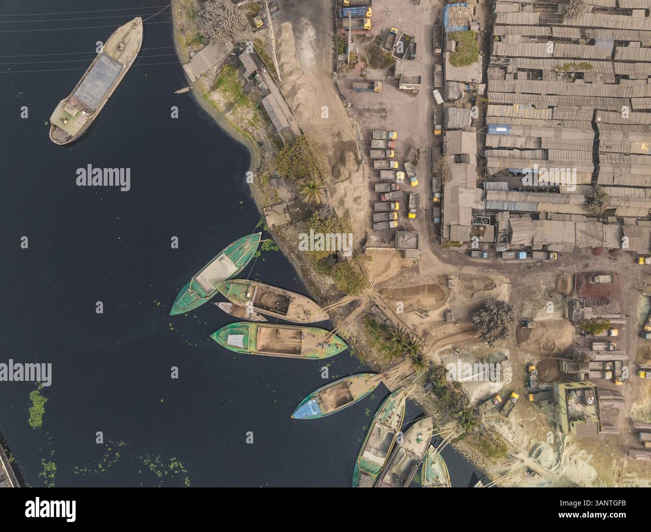 Aerial view of busy boats and cement industries along the river in an ...