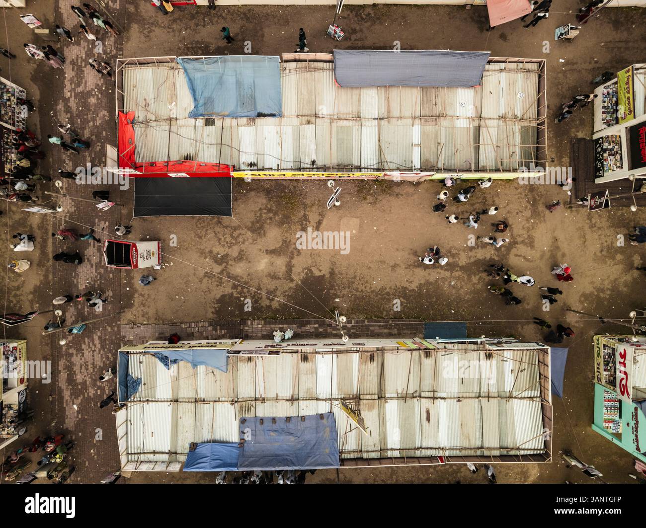 Aerial view of vibrant book fair with bustling stalls and people ...