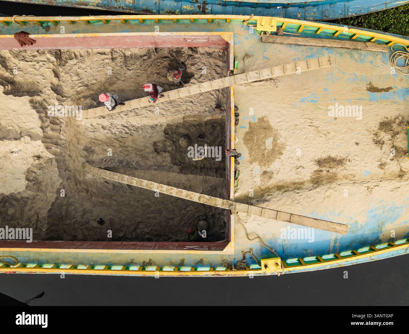 Aerial view of people working with boats and sand at cement industries ...