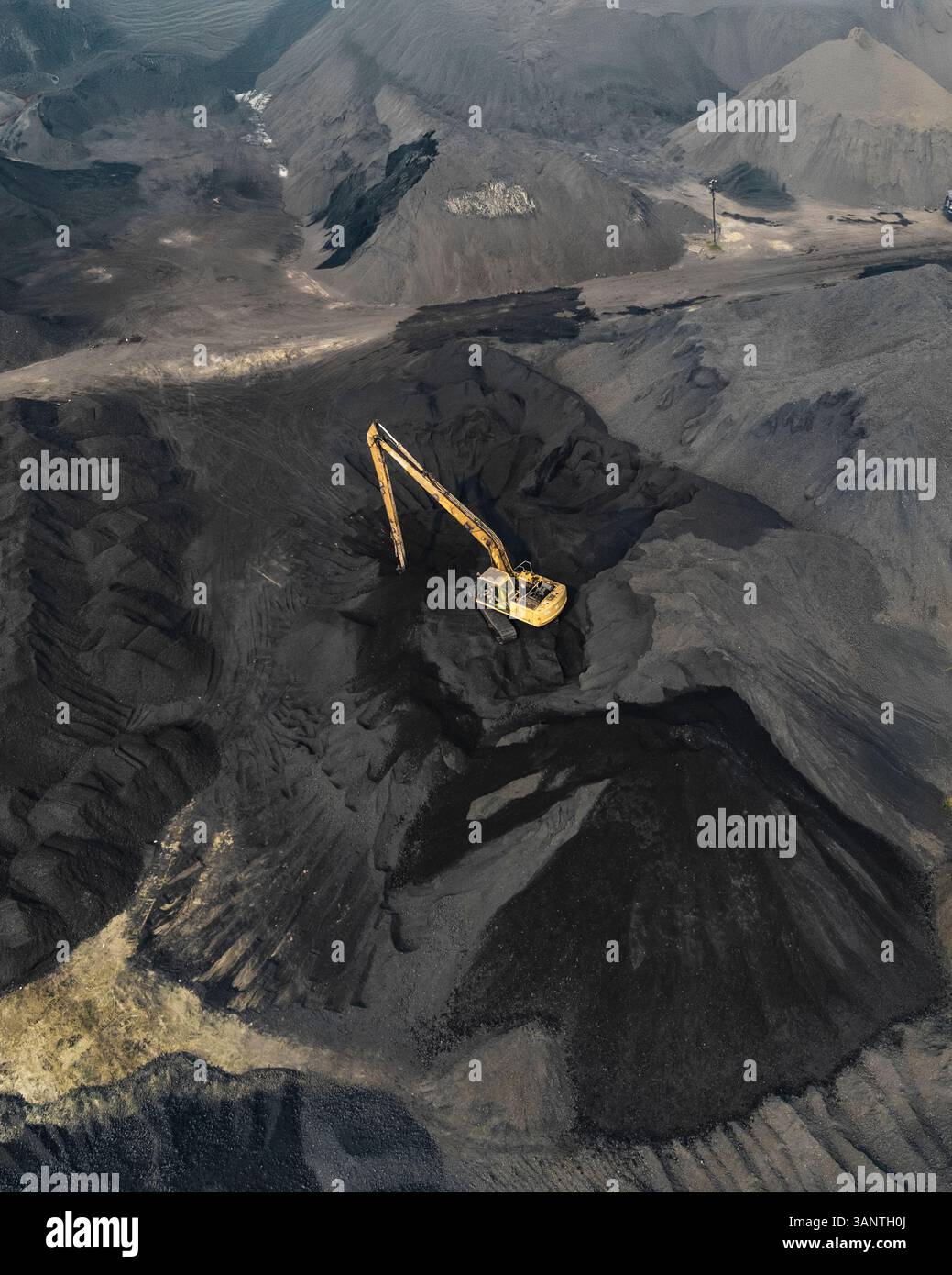 Aerial view of coal factory under construction with cranes and heavy ...