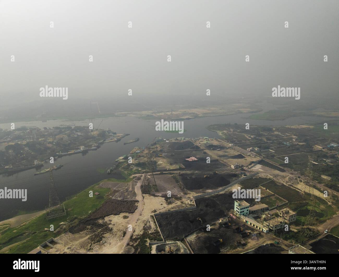 Aerial view of industrial landscape with cement industries, river, and ...