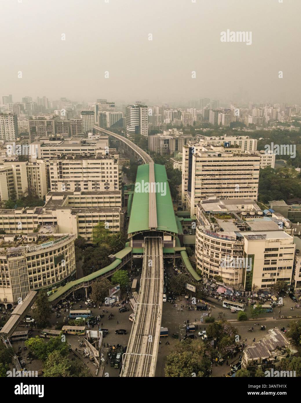 Aerial view of busy railway station and high-rise buildings in urban ...