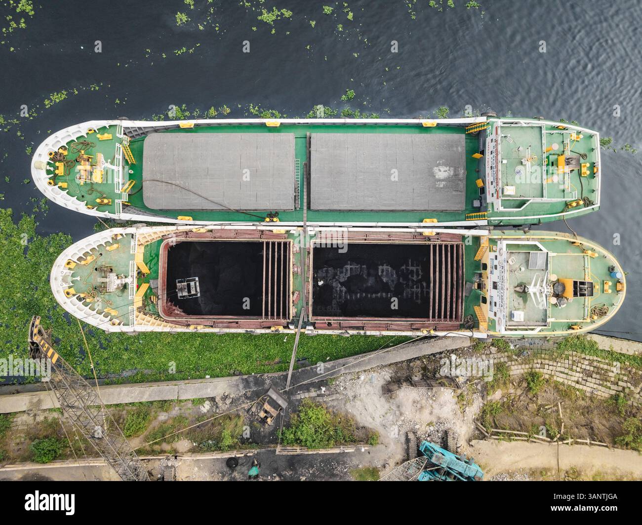 Aerial view of industrial coal factory with cranes and cargo ships ...