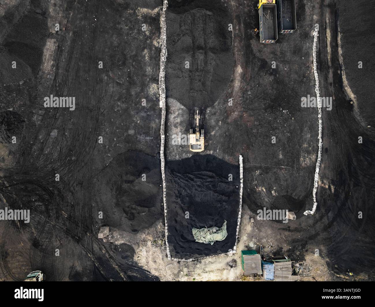 Aerial view of coal factory with crane and excavators in construction ...
