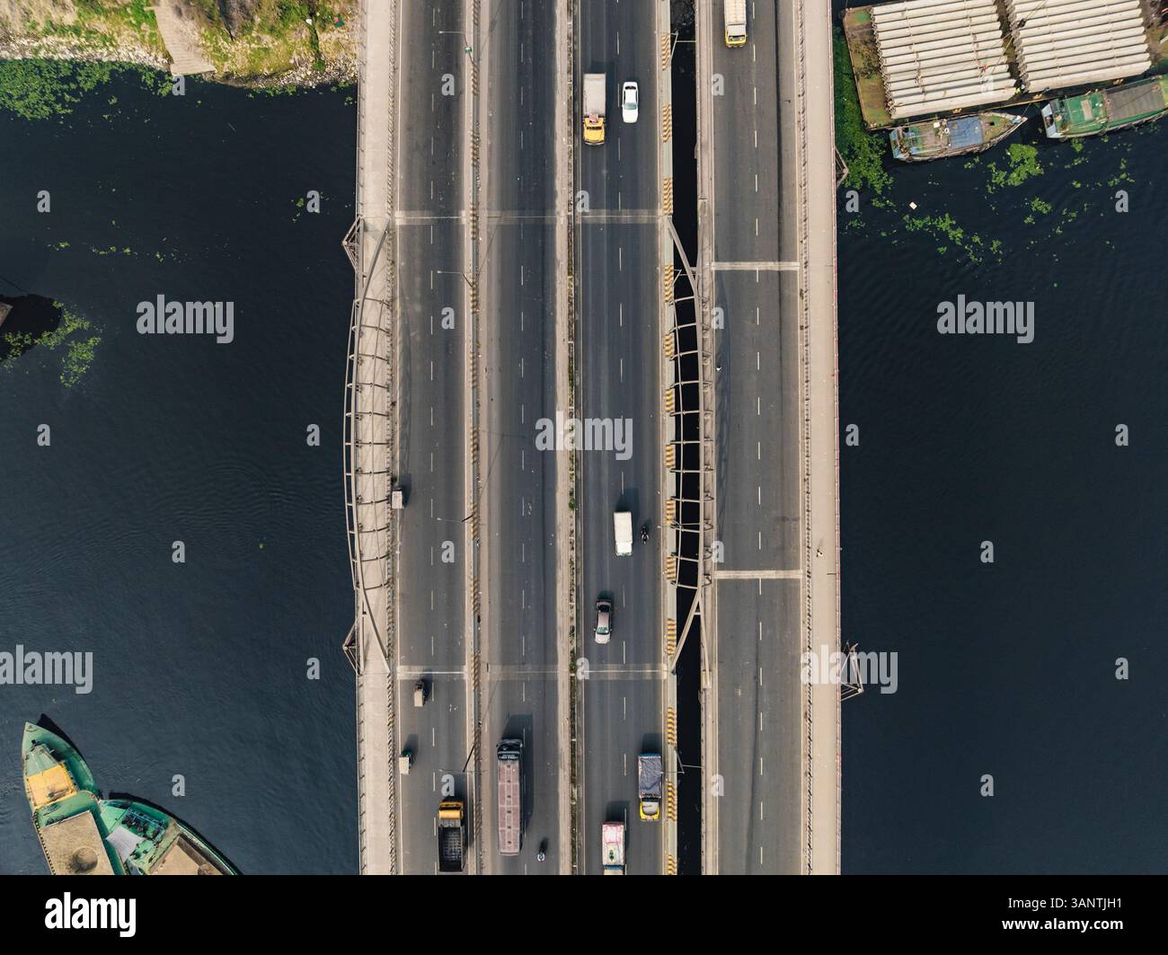 Aerial view of a bustling bridge with vehicles crossing over a river ...