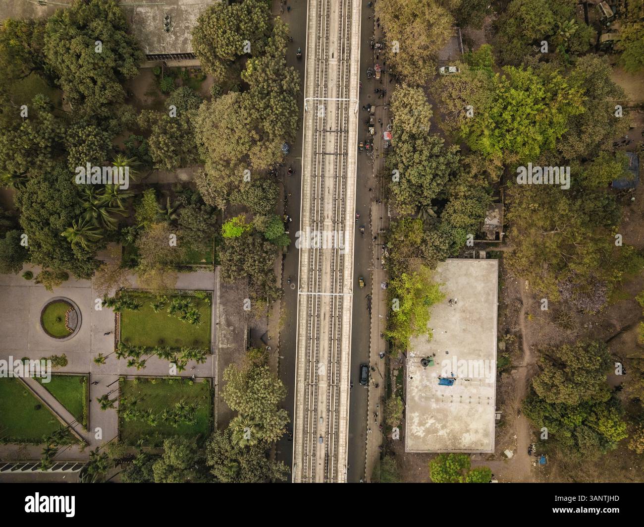 Aerial view of vibrant urban landscape featuring railway, trees ...