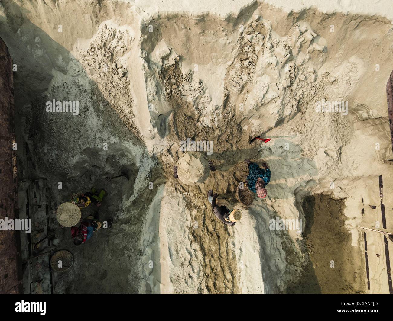 Aerial view of people working at an industrial construction site with ...