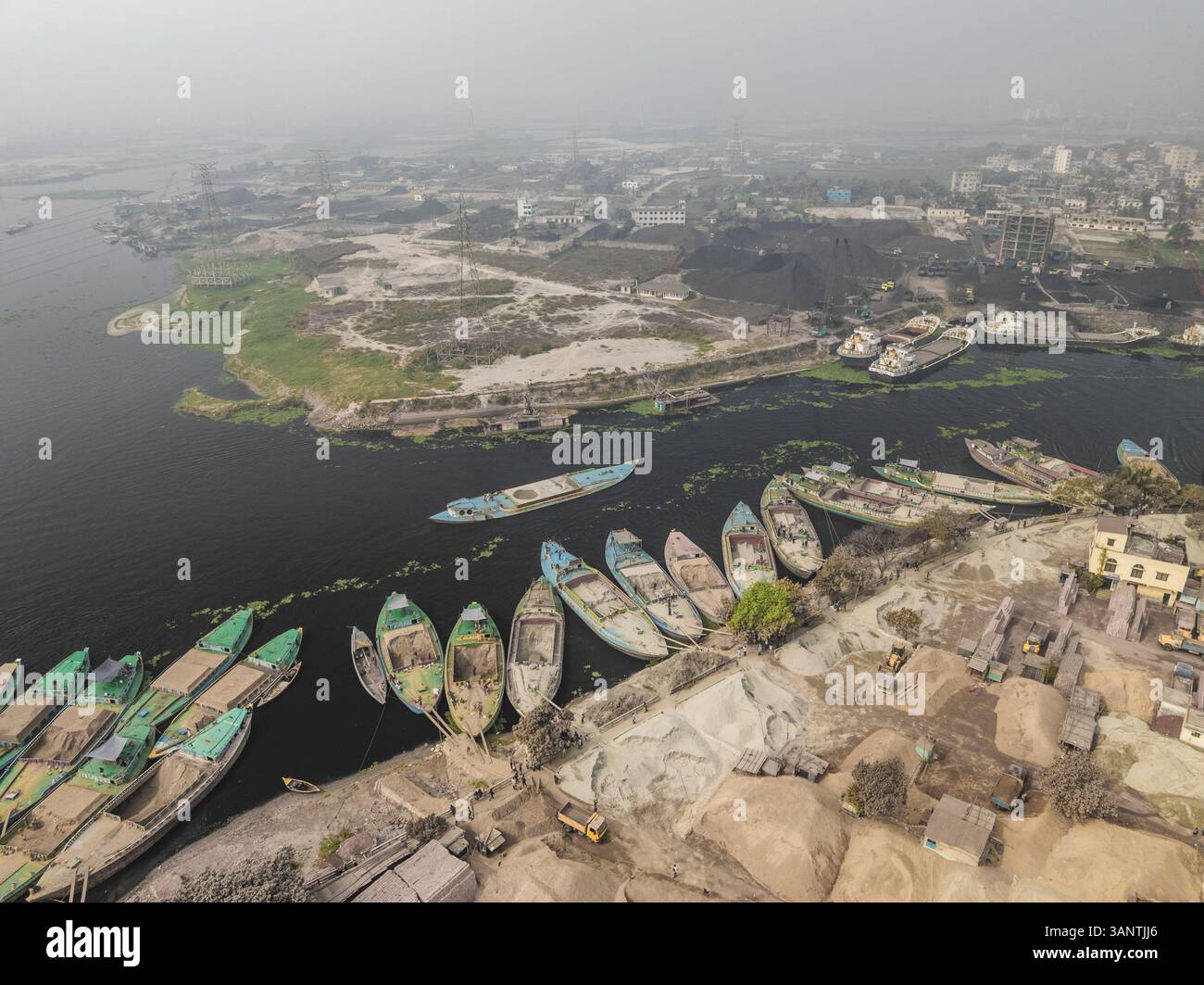 Aerial view of Buriganga river with boats and cement industries, Darus ...