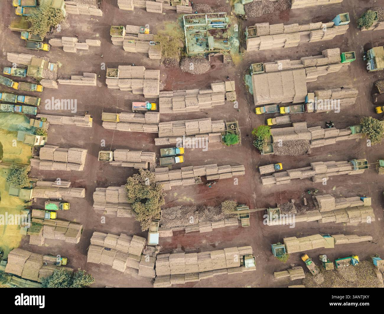 Aerial view of a brick factory surrounded by buildings and greenery ...