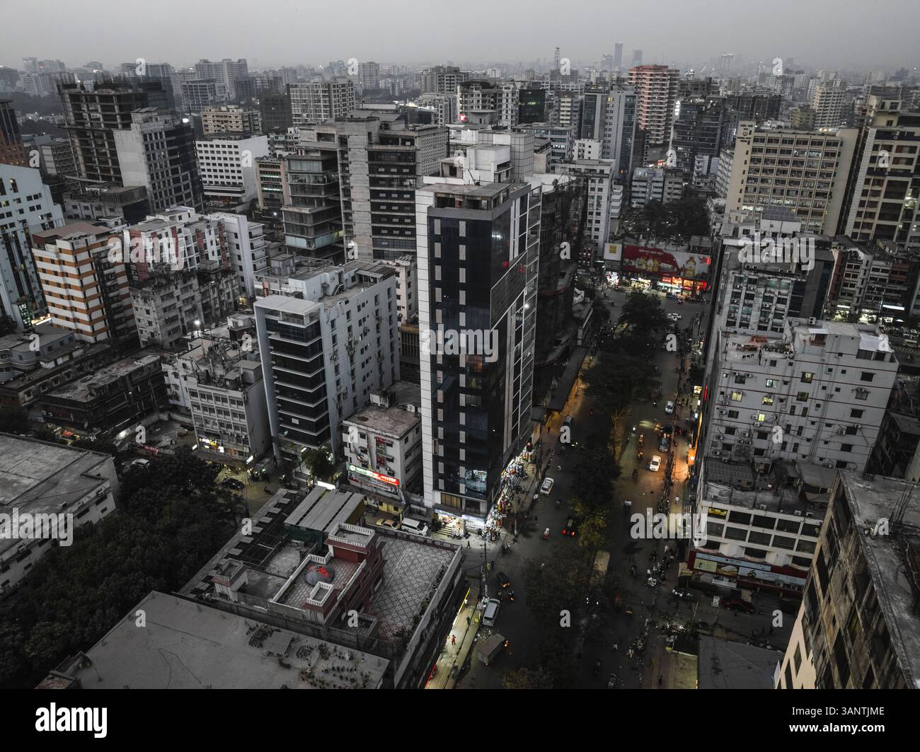 Aerial view of bustling cityscape with high-rise buildings and traffic in twilight, Paltan Thana ...