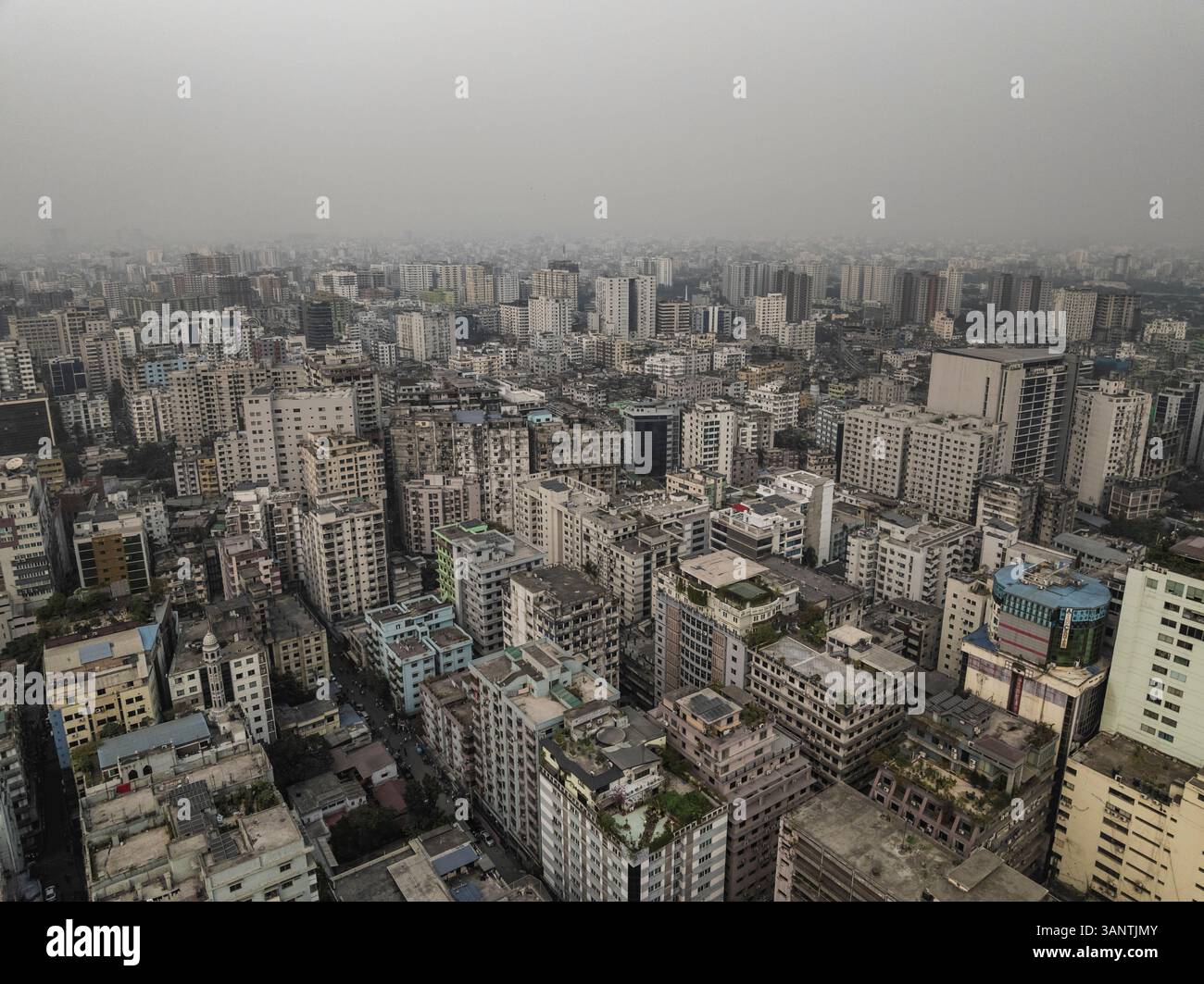 Aerial view of a bustling cityscape with modern skyscrapers and crowded urban sprawl, Paltan ...