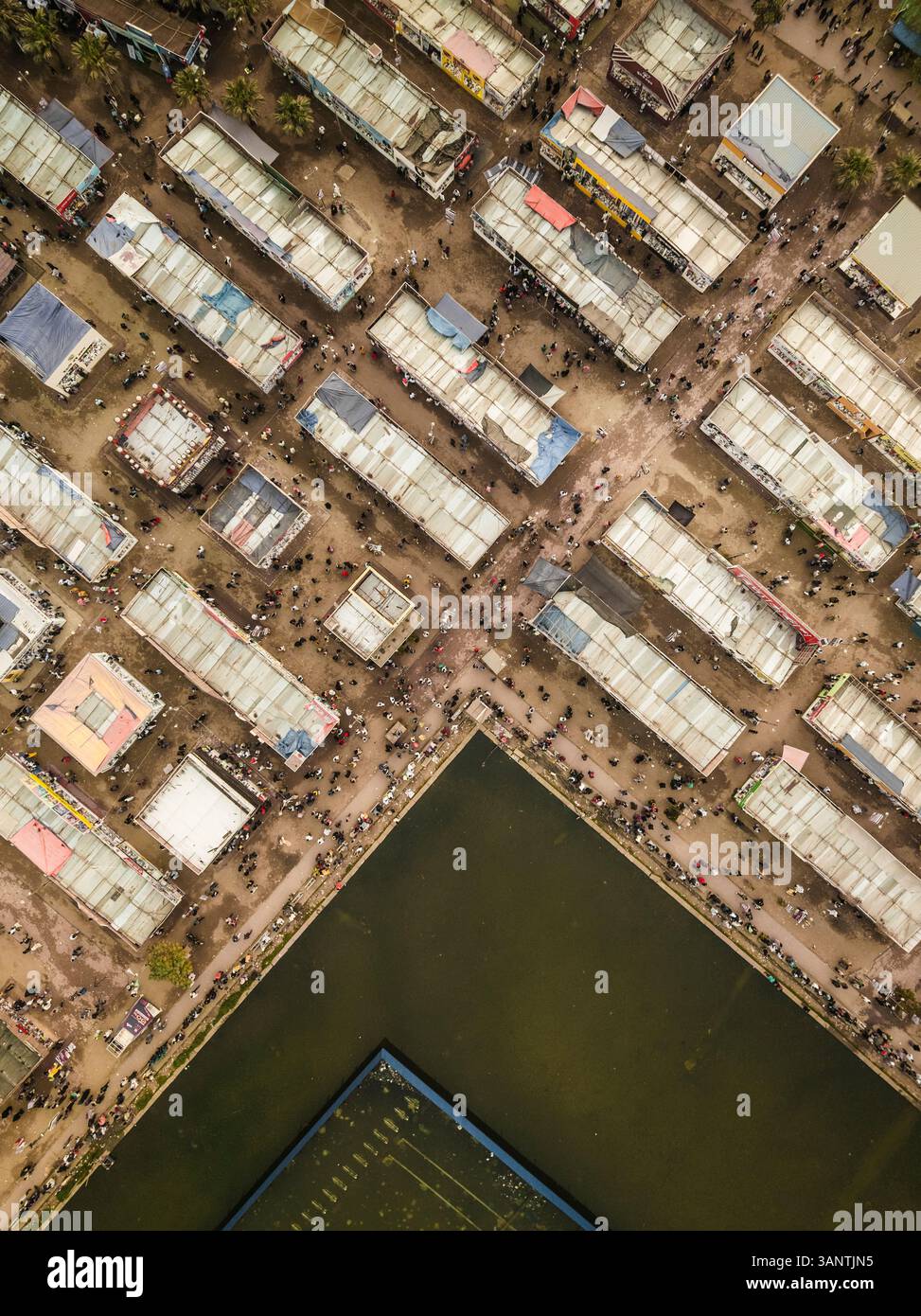 Aerial view of vibrant book fair with stalls and a bustling crowd ...