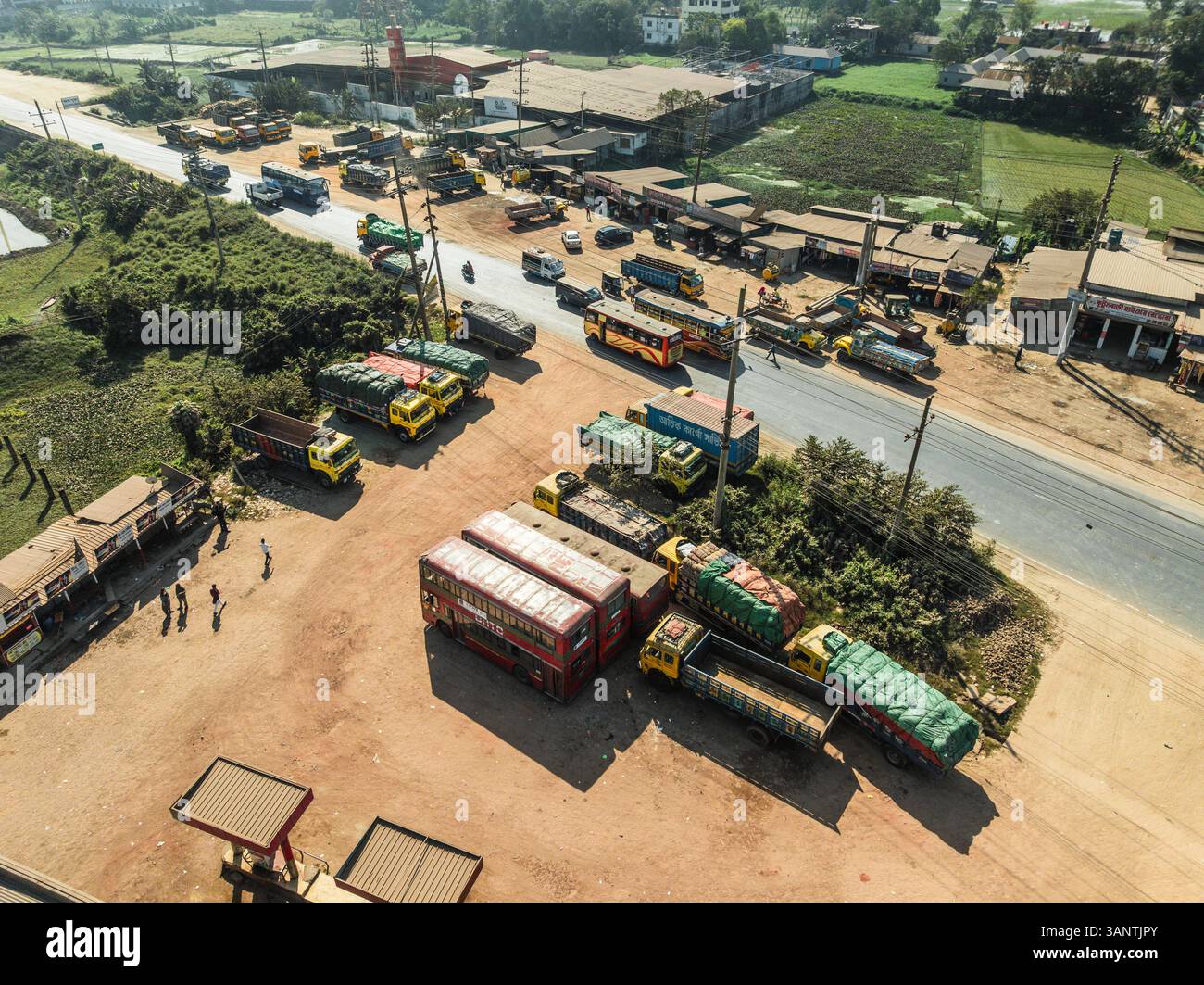 Aerial view of urban road with cars and trucks amidst industrial ...