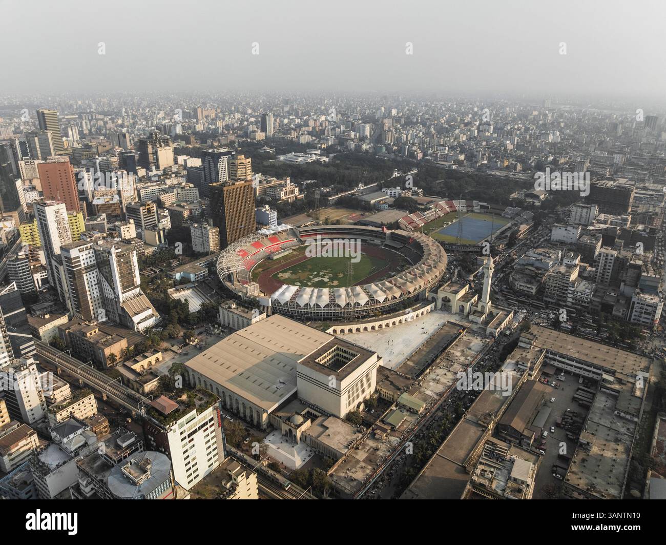 Aerial view of bangabandhu national stadium surrounded by bustling cityscape and high-rise ...
