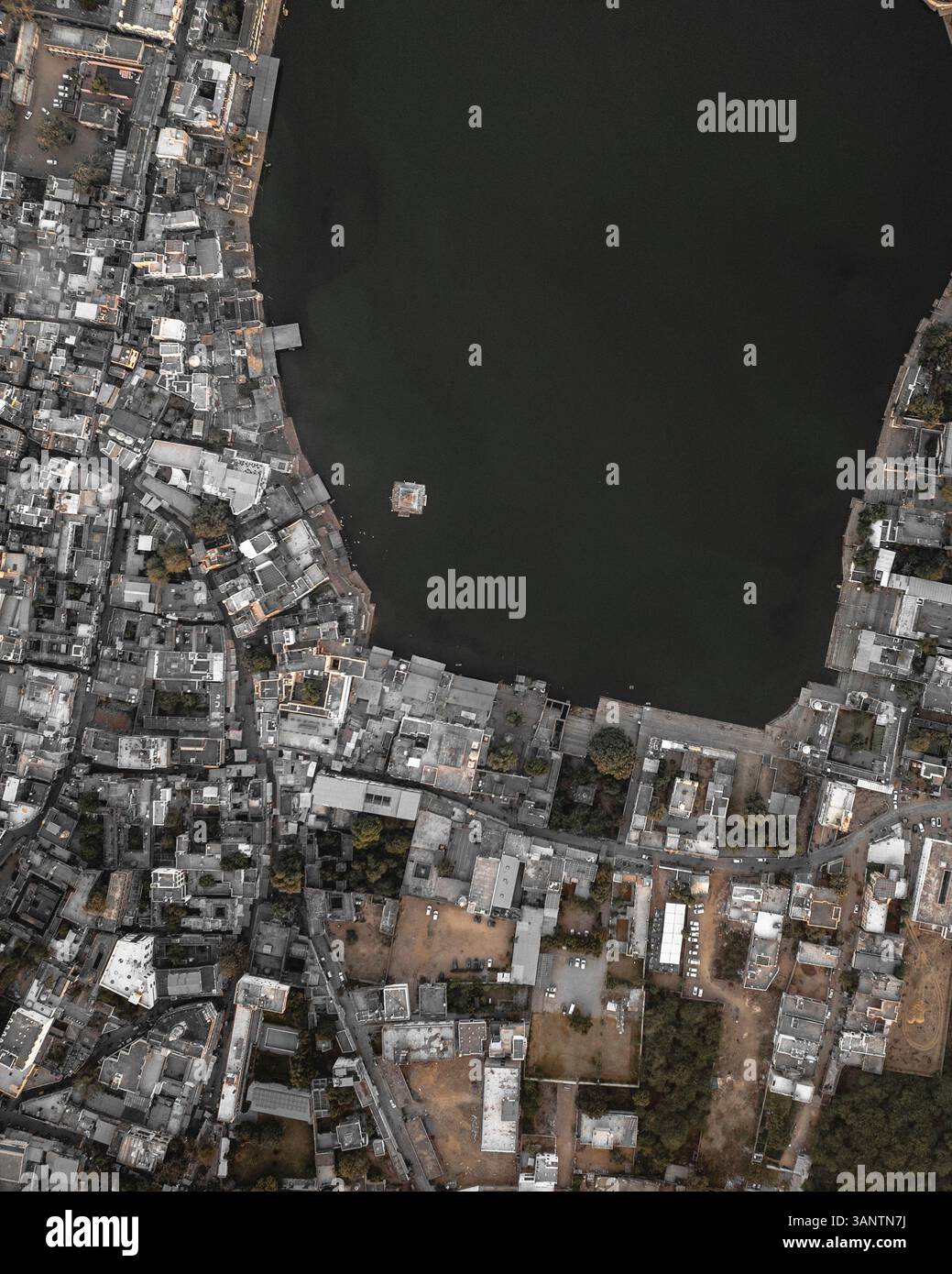Aerial view of densely populated cityscape with buildings and a lake ...