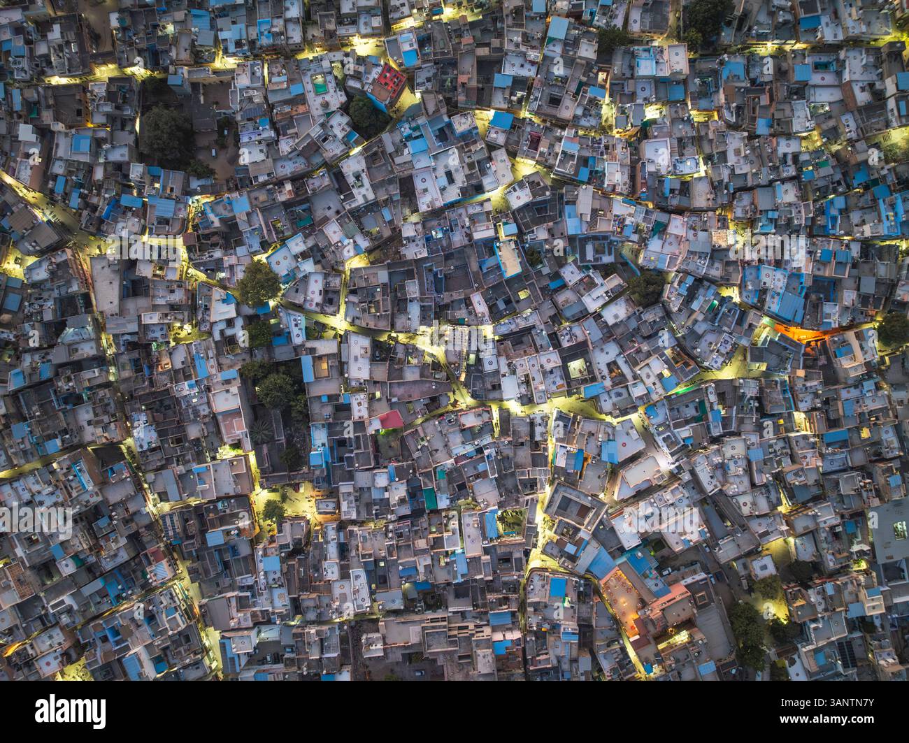 Aerial view of illuminated rooftops and buildings in a dense urban ...
