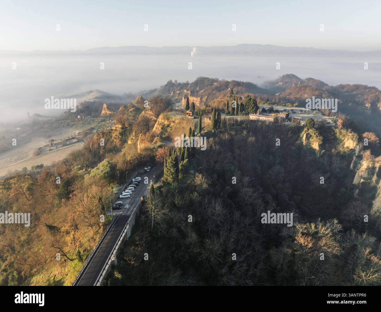 Aerial view of balze valdarno shrouded in fog and mist at sunrise ...