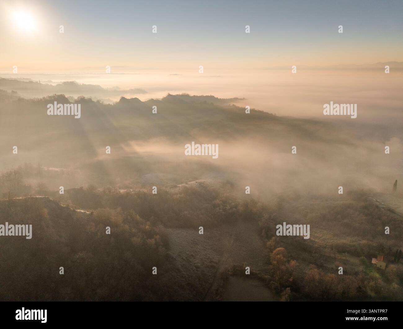 Aerial view of tranquil sunrise over the misty Balze Valdarno valley ...