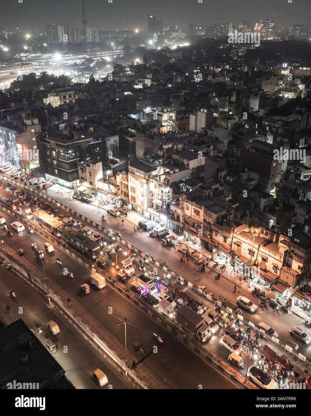 Aerial view of bustling cityscape with vibrant street lights and busy ...