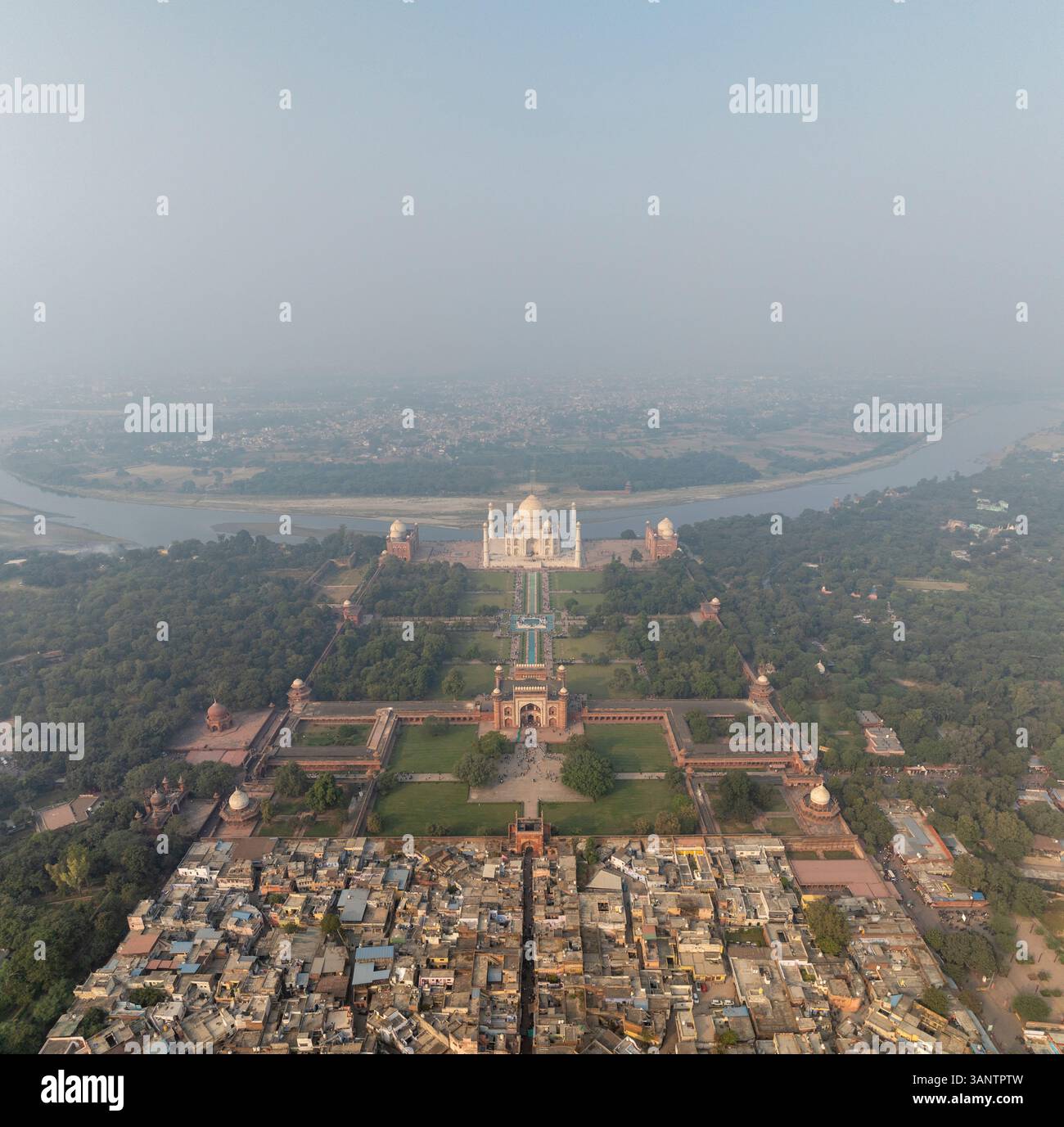 Aerial view of the iconic Taj Mahal surrounded by beautiful gardens and a river, Agra, India ...