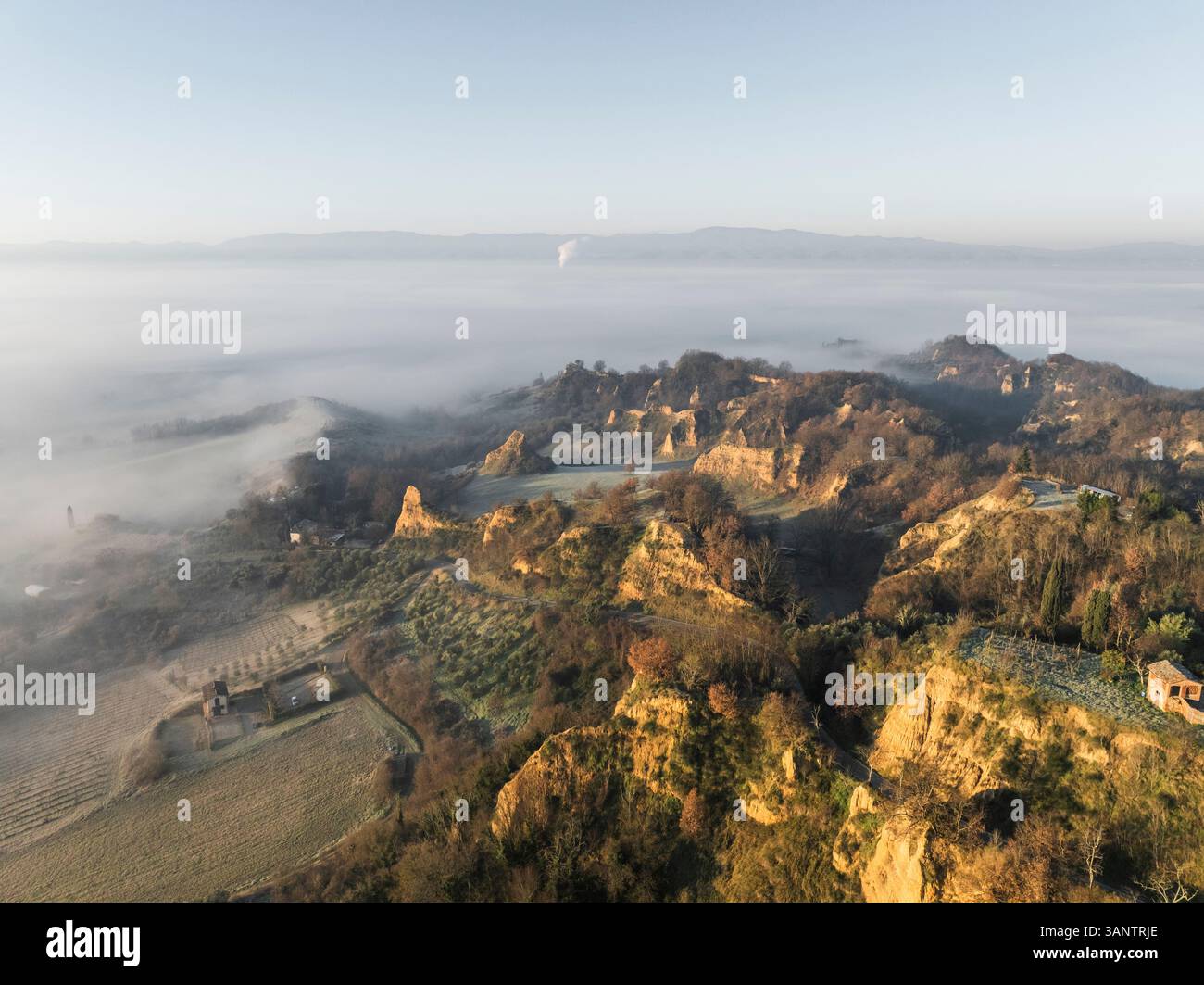 Aerial view of balze valdarno shrouded in fog and mist at sunrise with ...