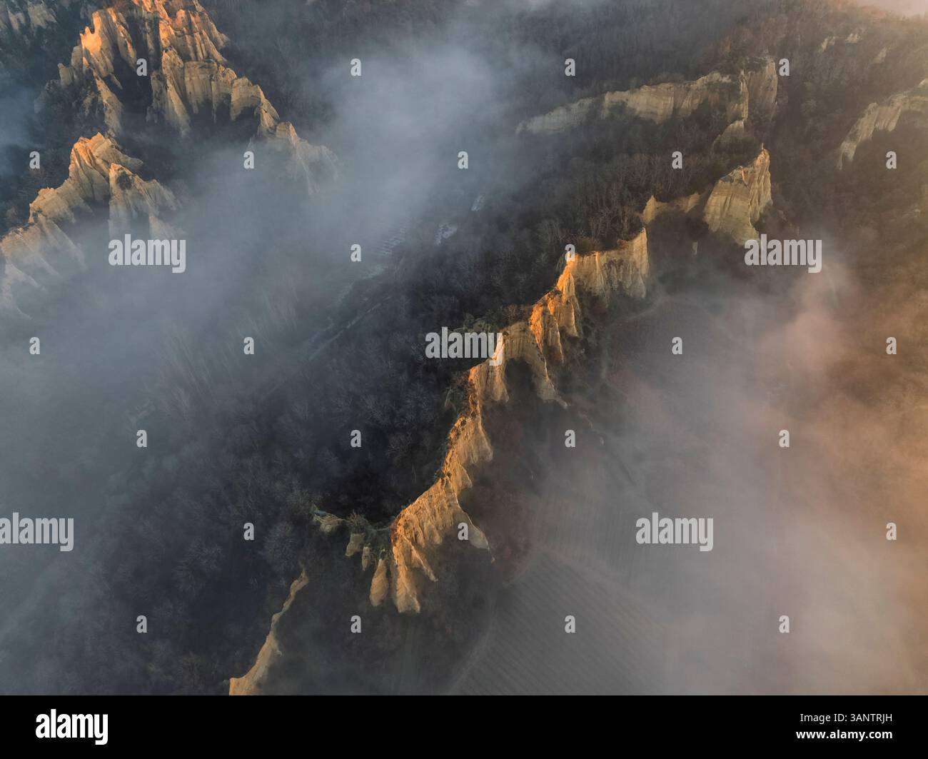 Aerial view of balze valdarno covered in fog and mist at sunrise ...
