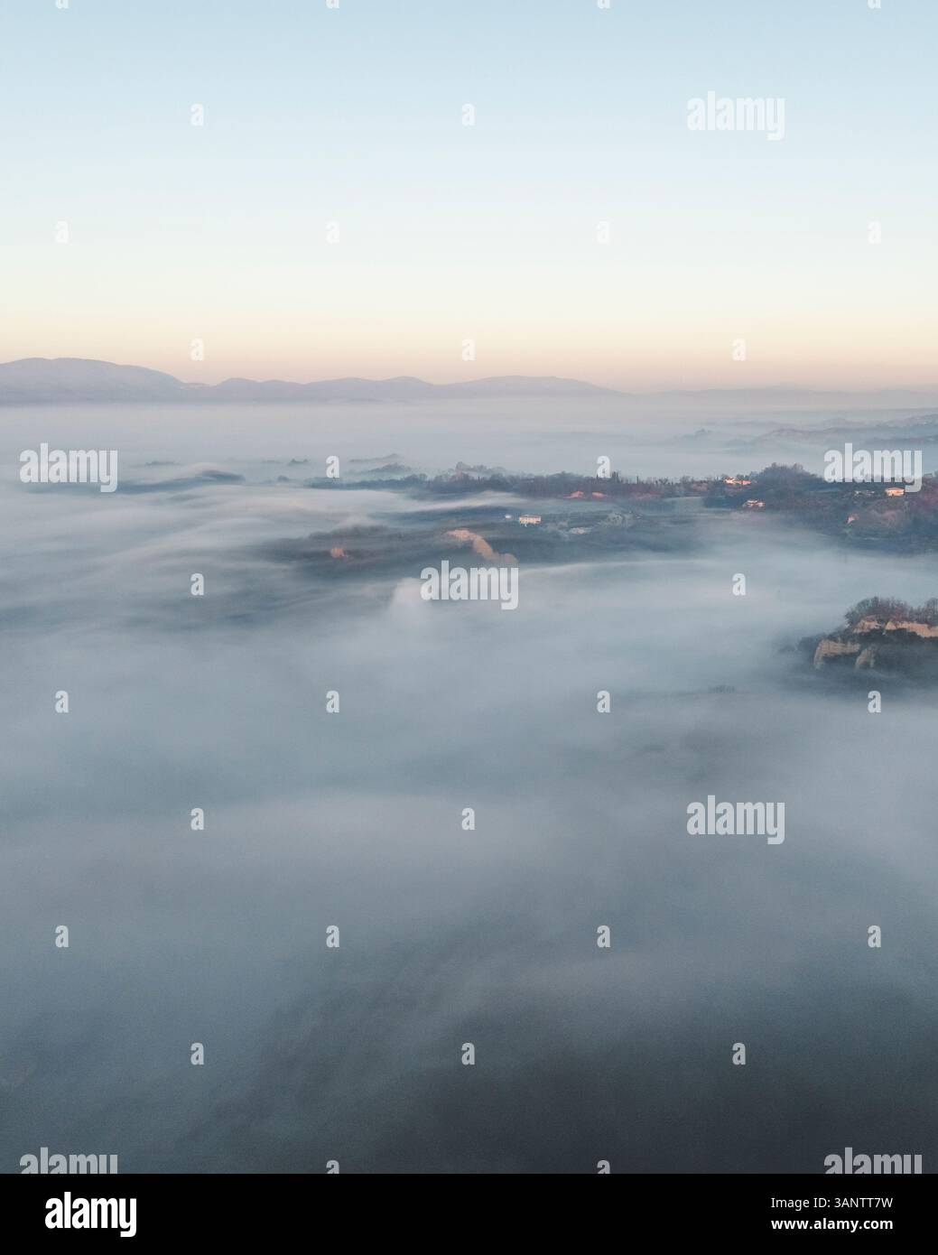Aerial view of balze valdarno shrouded in fog and mist at sunrise ...