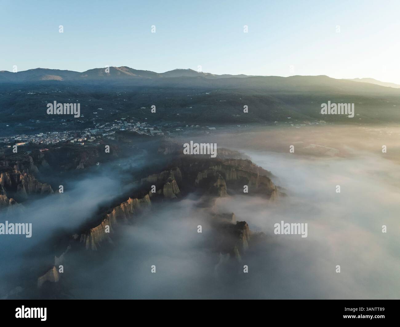 Aerial view of balze valdarno covered in fog and mist during sunrise ...